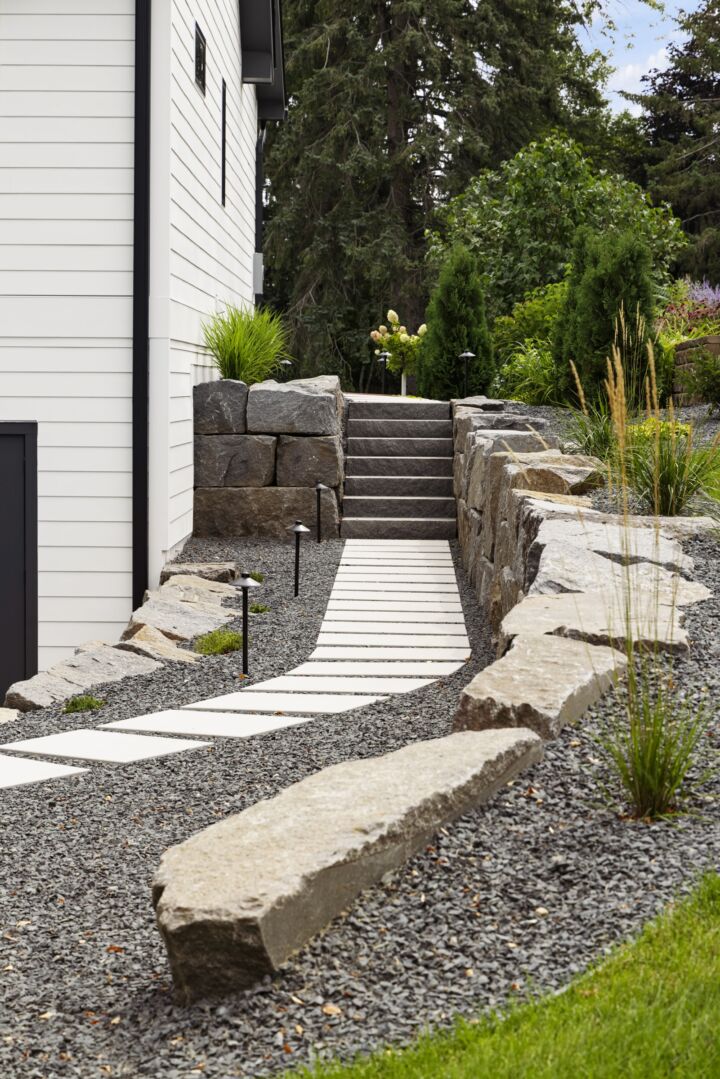 Backyard boulder wall w/ pathway and lighting – Gary Anderson Landscaping